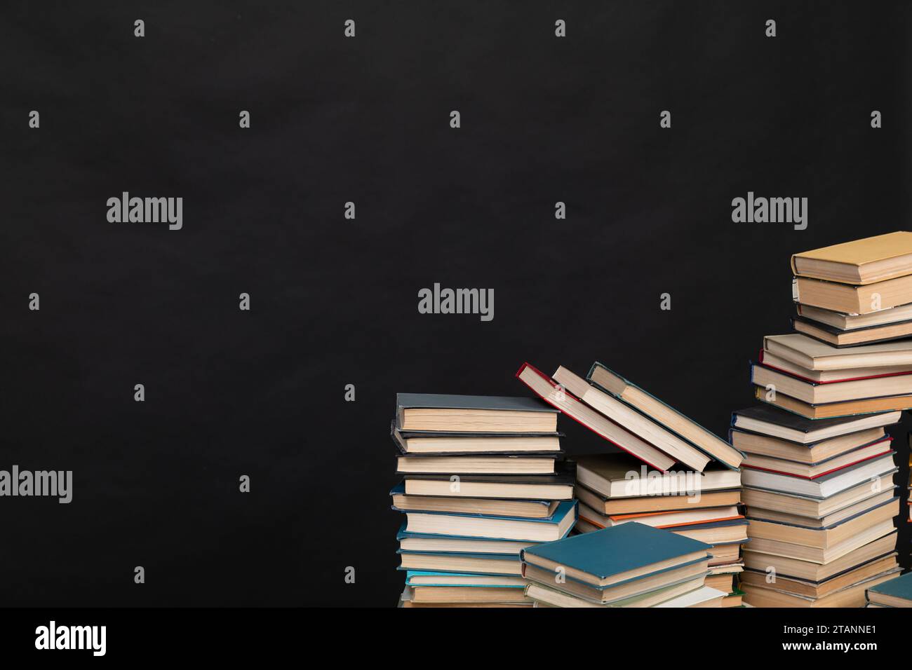 stack of books on a black background library education Stock Photo - Alamy