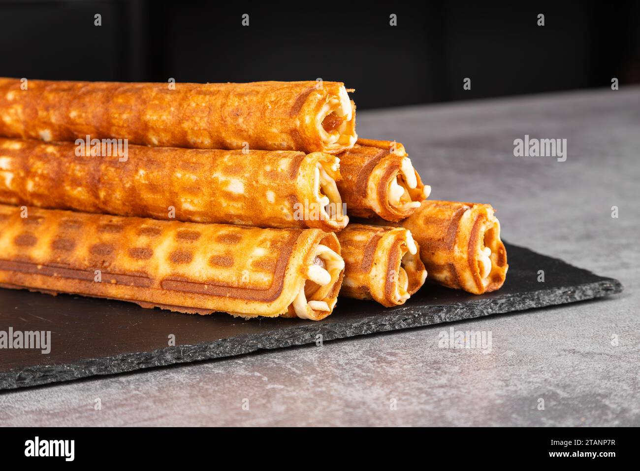 Homemade waffles with caramel. Wafer rolls with condensed milk. Thin ...