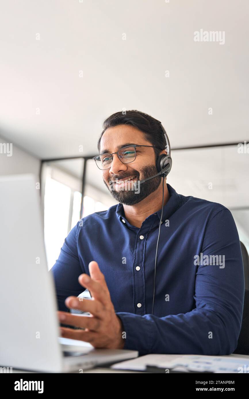 Happy Indian call center agent in headset working in customer support ...