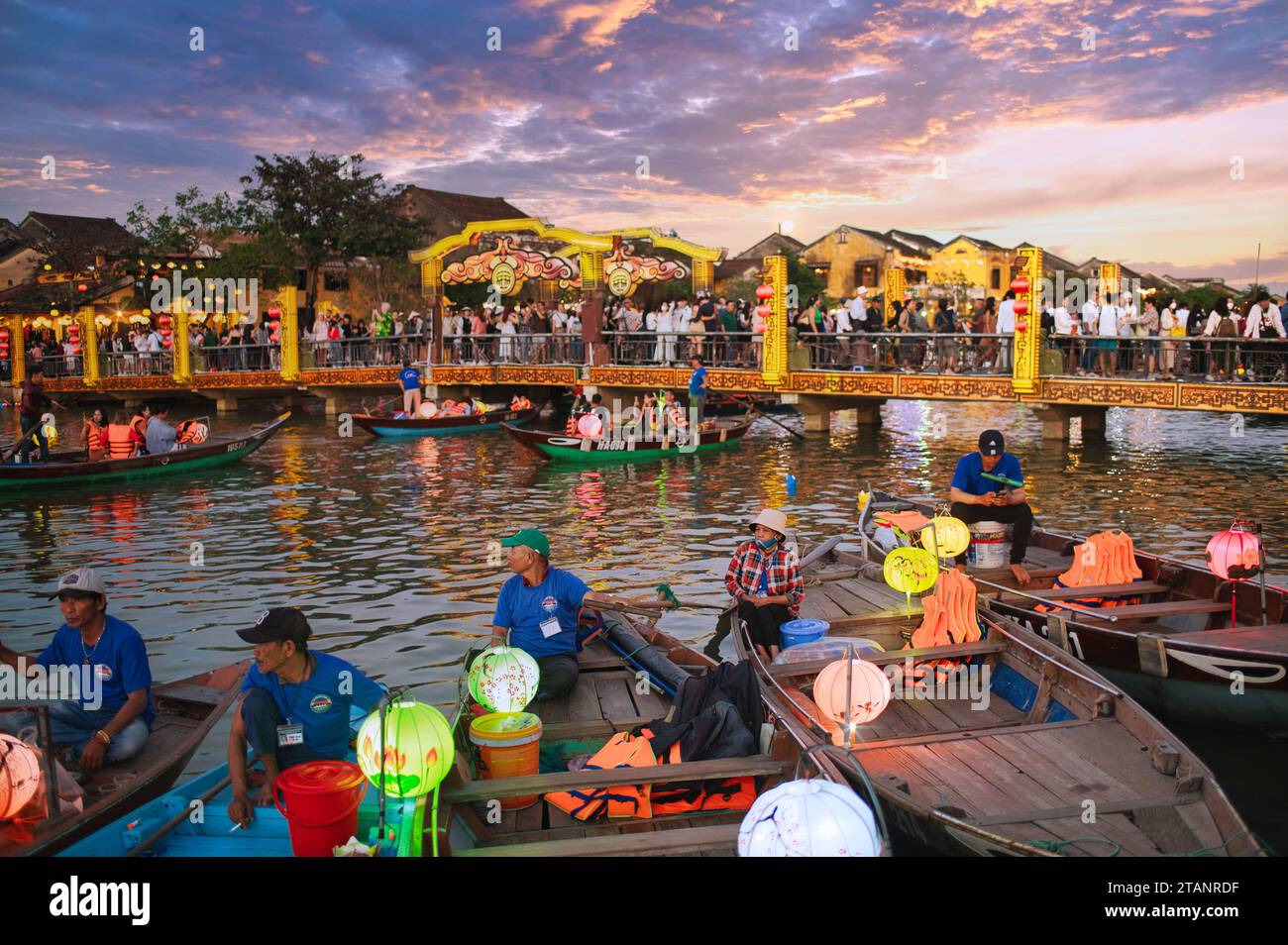 Group of people sitting on pier Stock Photo - Alamy