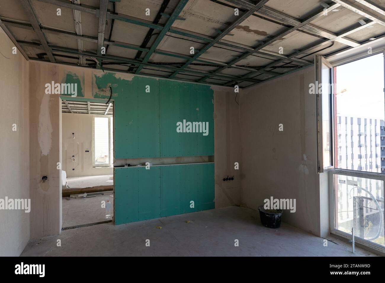 Drywall installation work in progress by construction workers at ...
