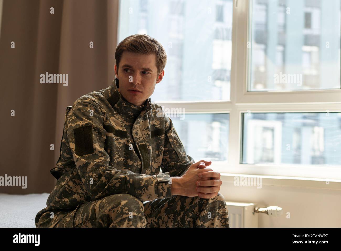 Thoughtful young handsome soldier in military uniform Stock Photo - Alamy