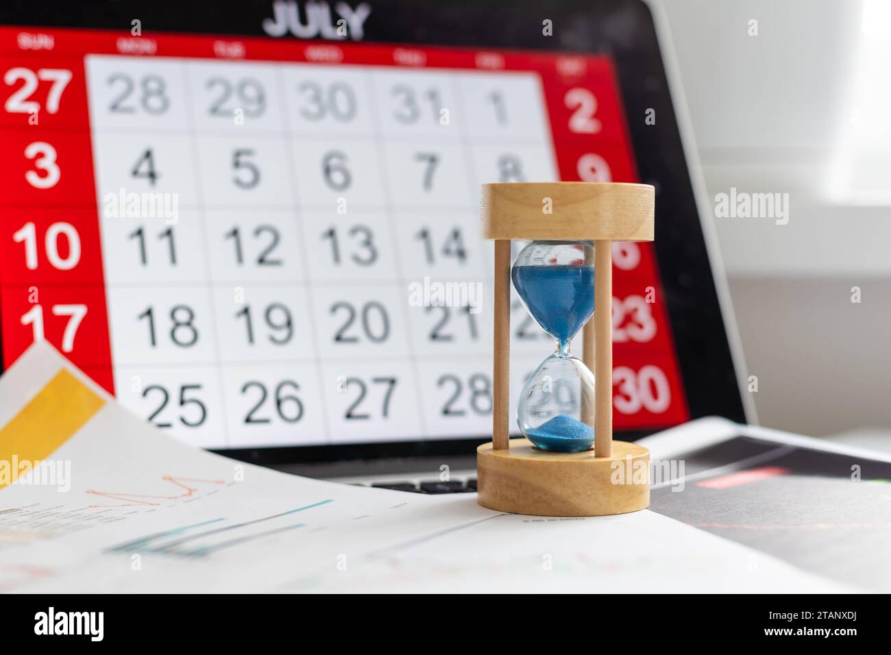 Time passing concept, time slipping away. Hourglass and the calendar ...