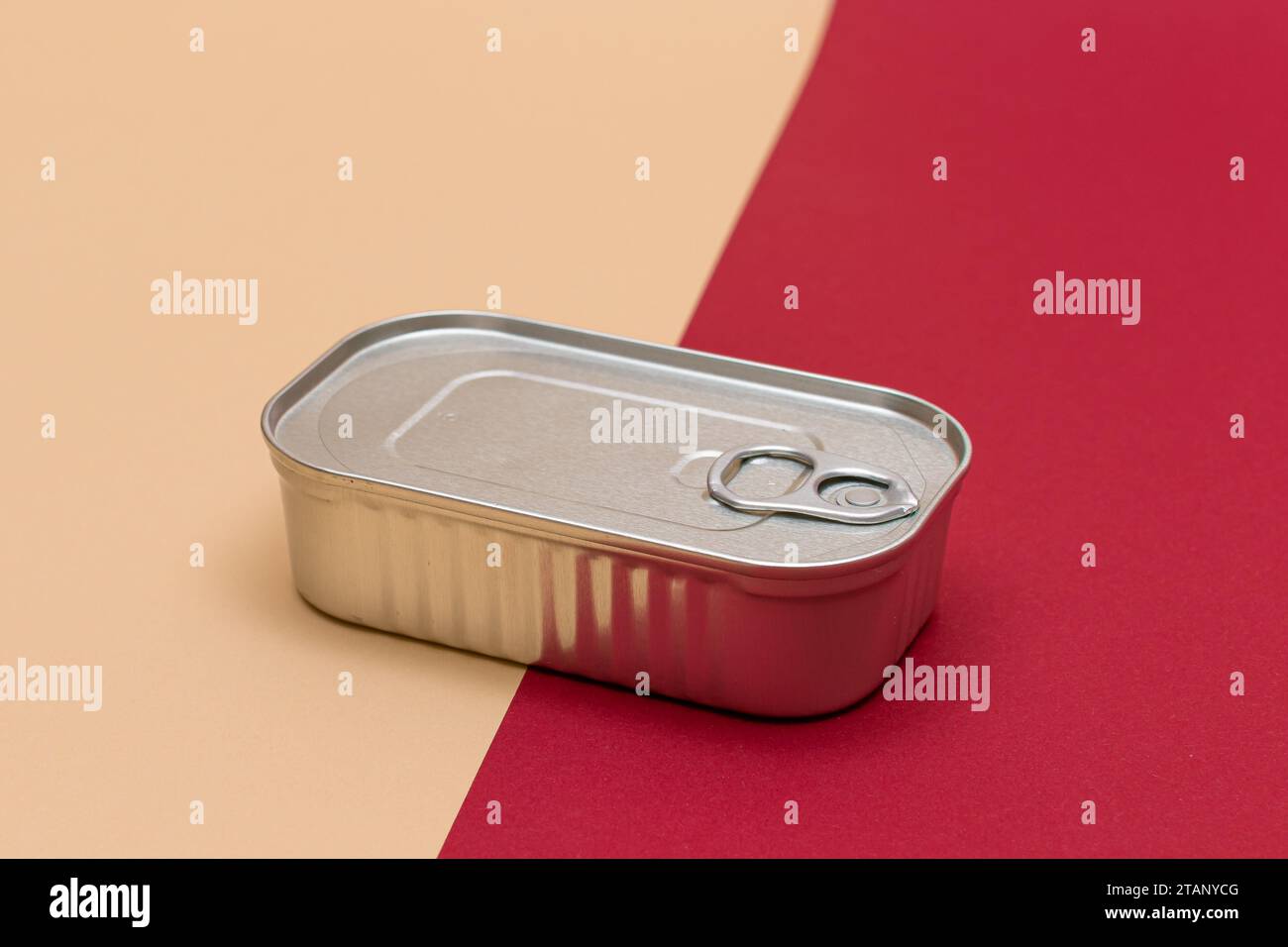 Unopened Tin Can with Blank Edge on Split Red and Beige Background ...