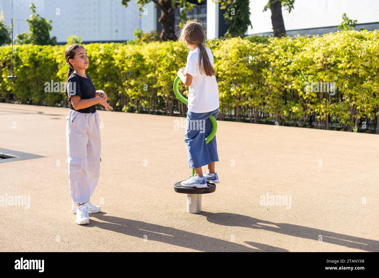 Two children spining on carousel and laughing loudly, hanging out ...