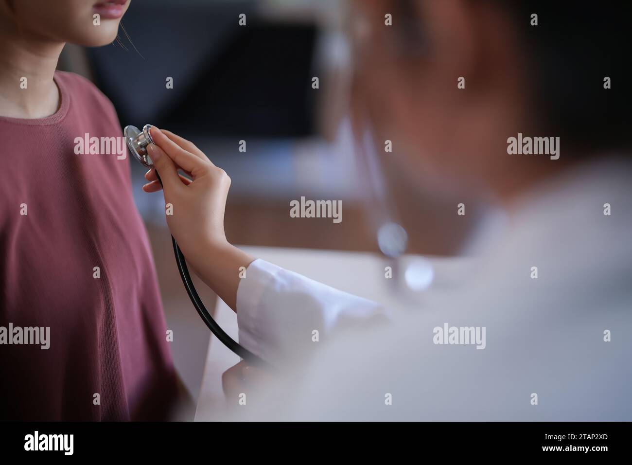 Asian psychologist women use stethoscope to examining heartbeat of ...
