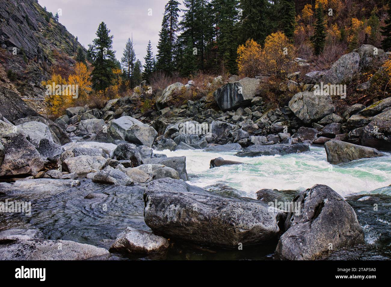 The White water rapids through rocks and surrounded by fall foliage in ...