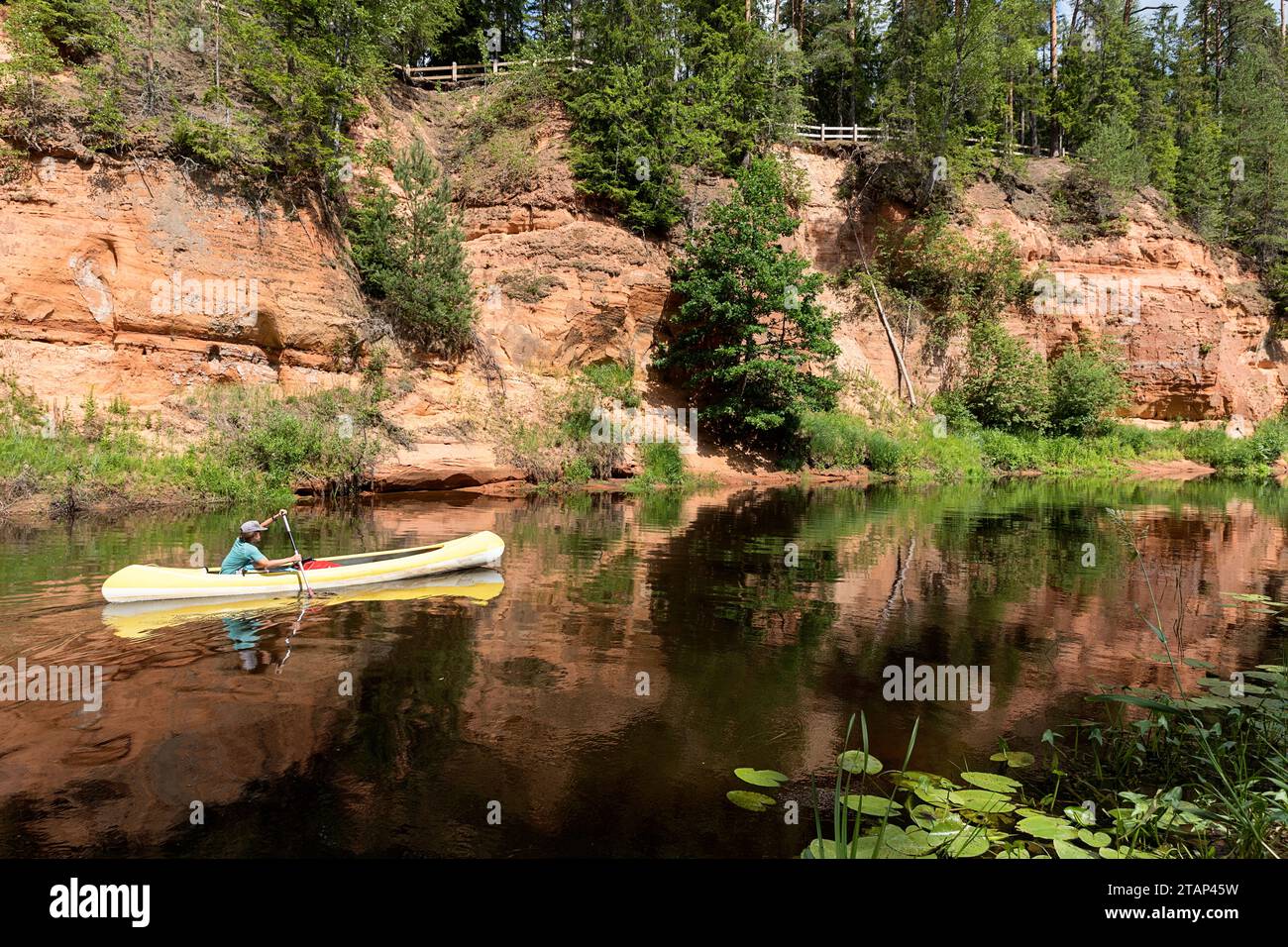 Tourist on a canoe, boat trip on Salaca river, exploring spectacular ...