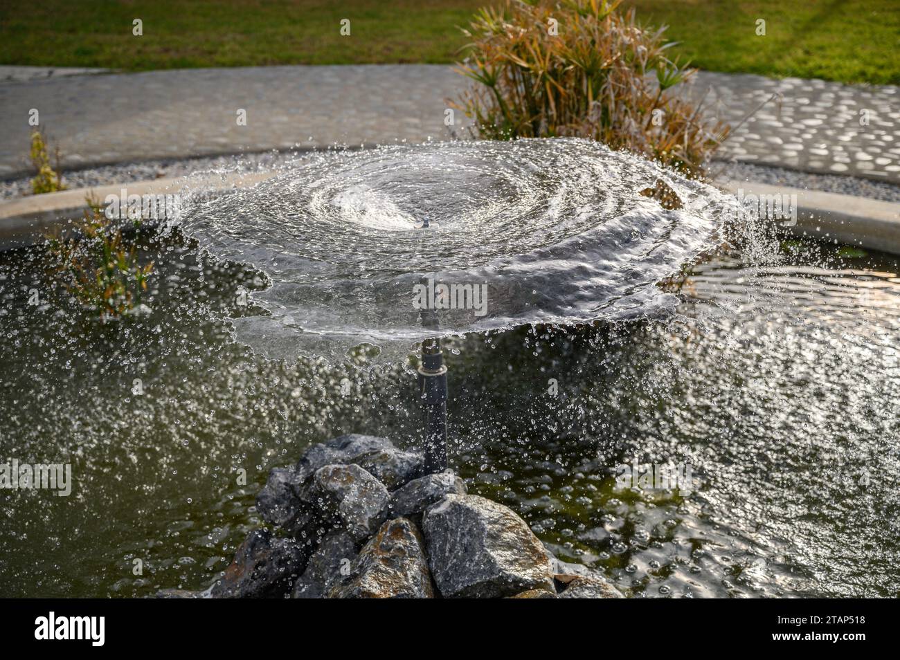 circle of water from a fountain spraying water 2 Stock Photo - Alamy