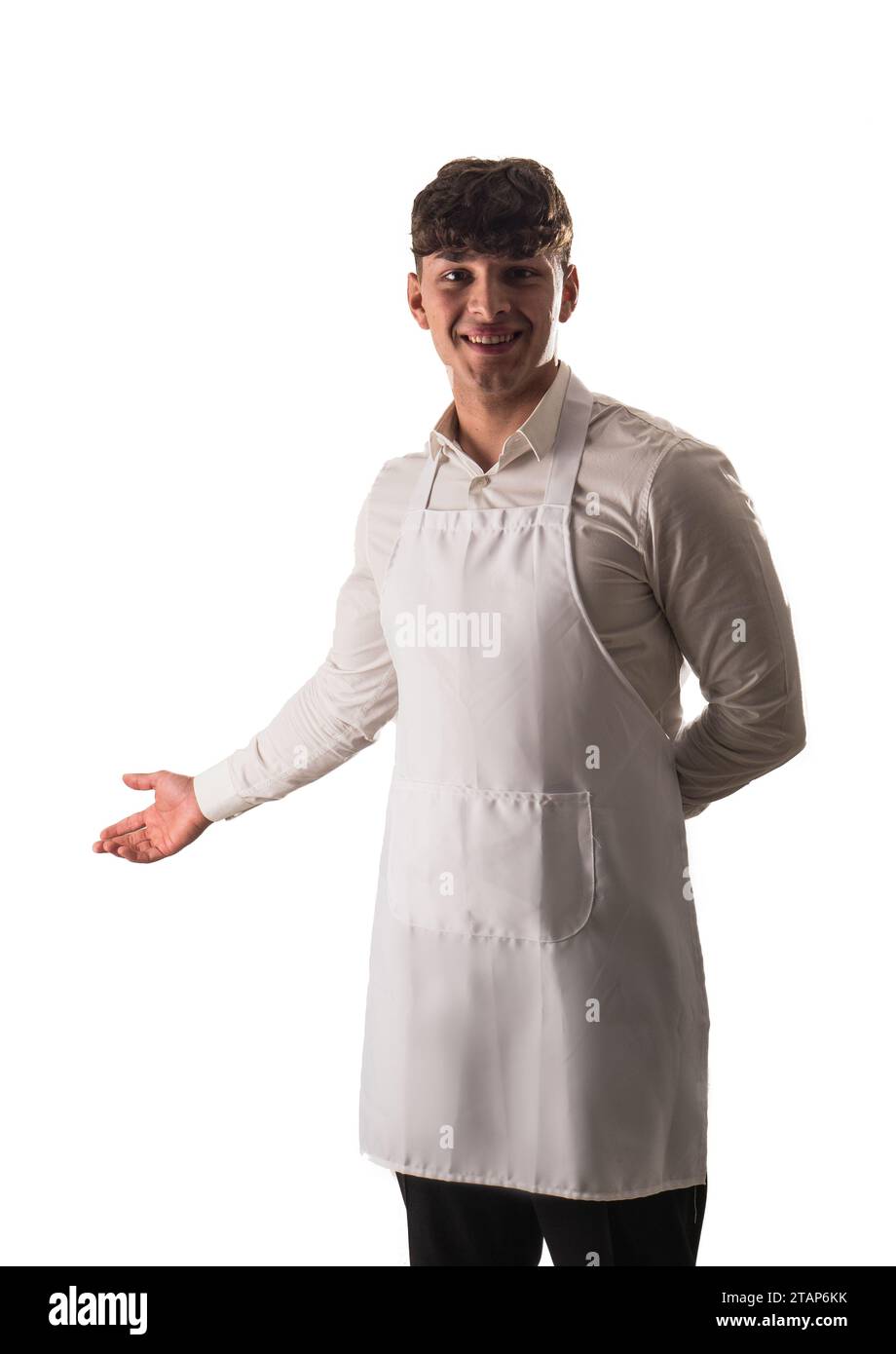 Young chef or waiter posing, wearing white apron and white shirt ...