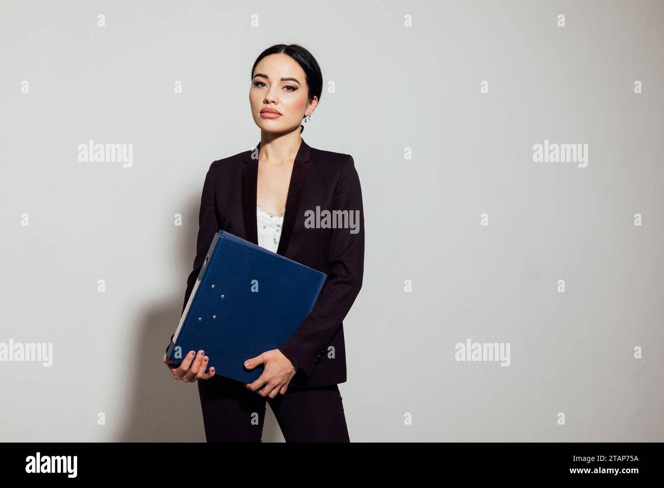 Woman in business suit with folders in office space Stock Photo - Alamy