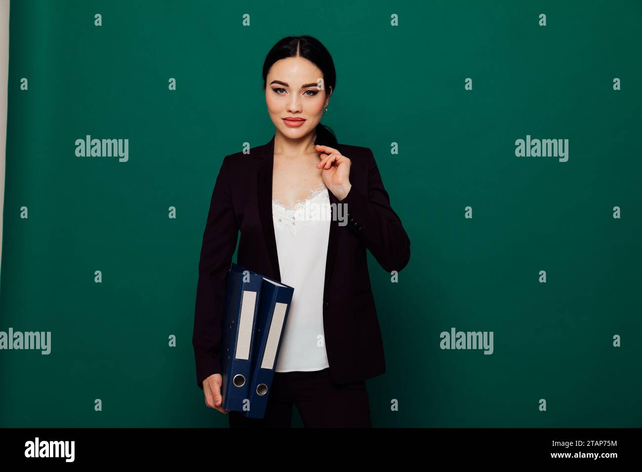 Woman in business suit with folders in office space Stock Photo - Alamy
