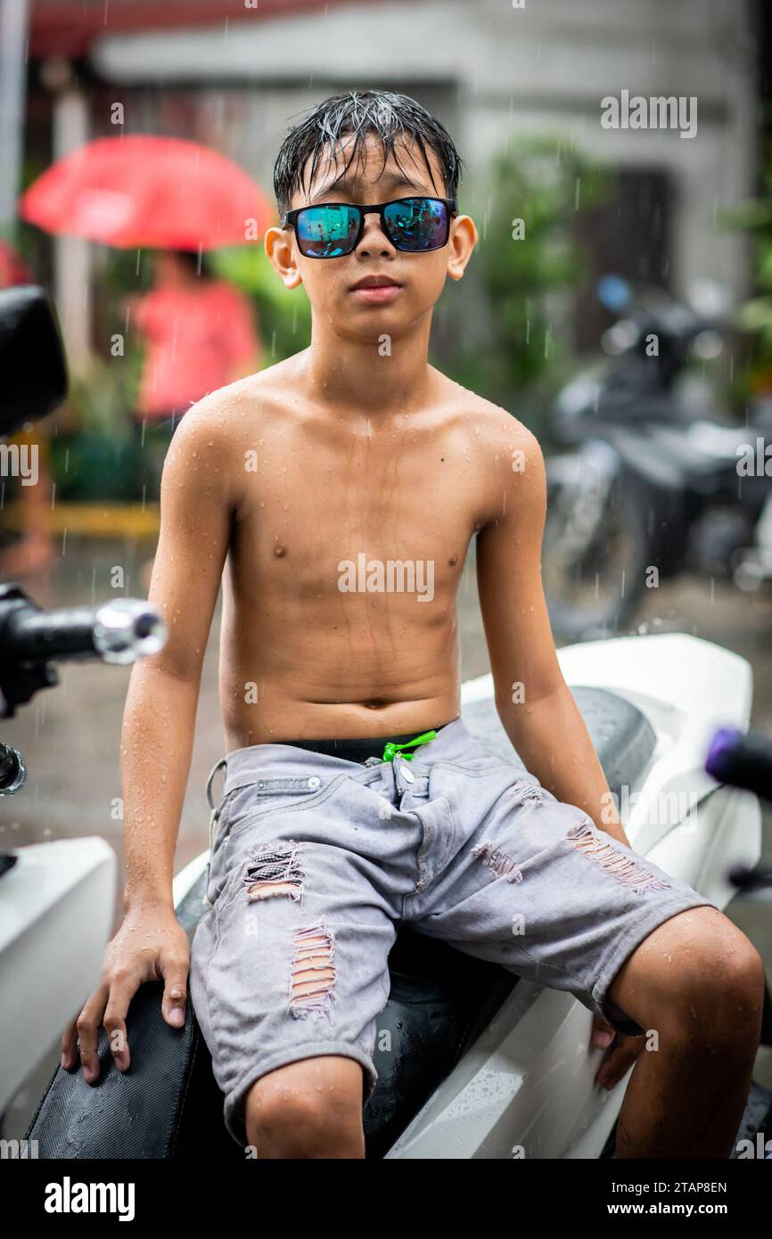 A cool little Filipino boy strikes a cool pose with his shades on in ...