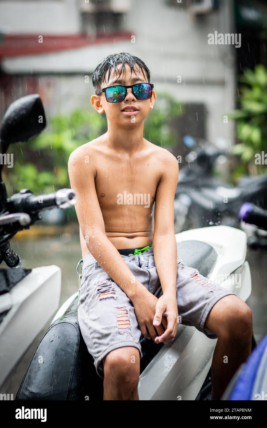 A cool little Filipino boy strikes a cool pose with his shades on in ...