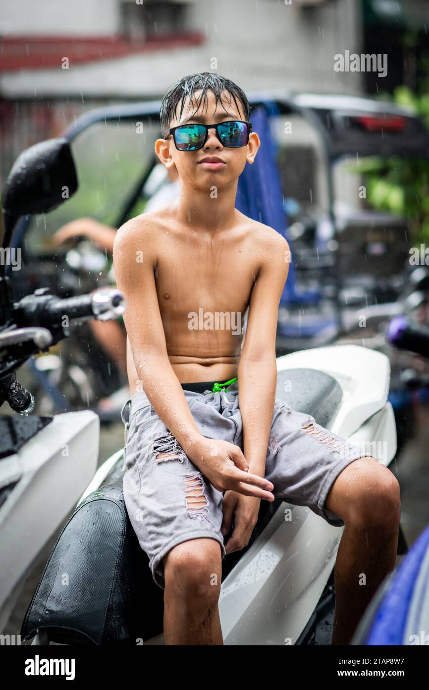 A cool little Filipino boy strikes a cool pose with his shades on in ...