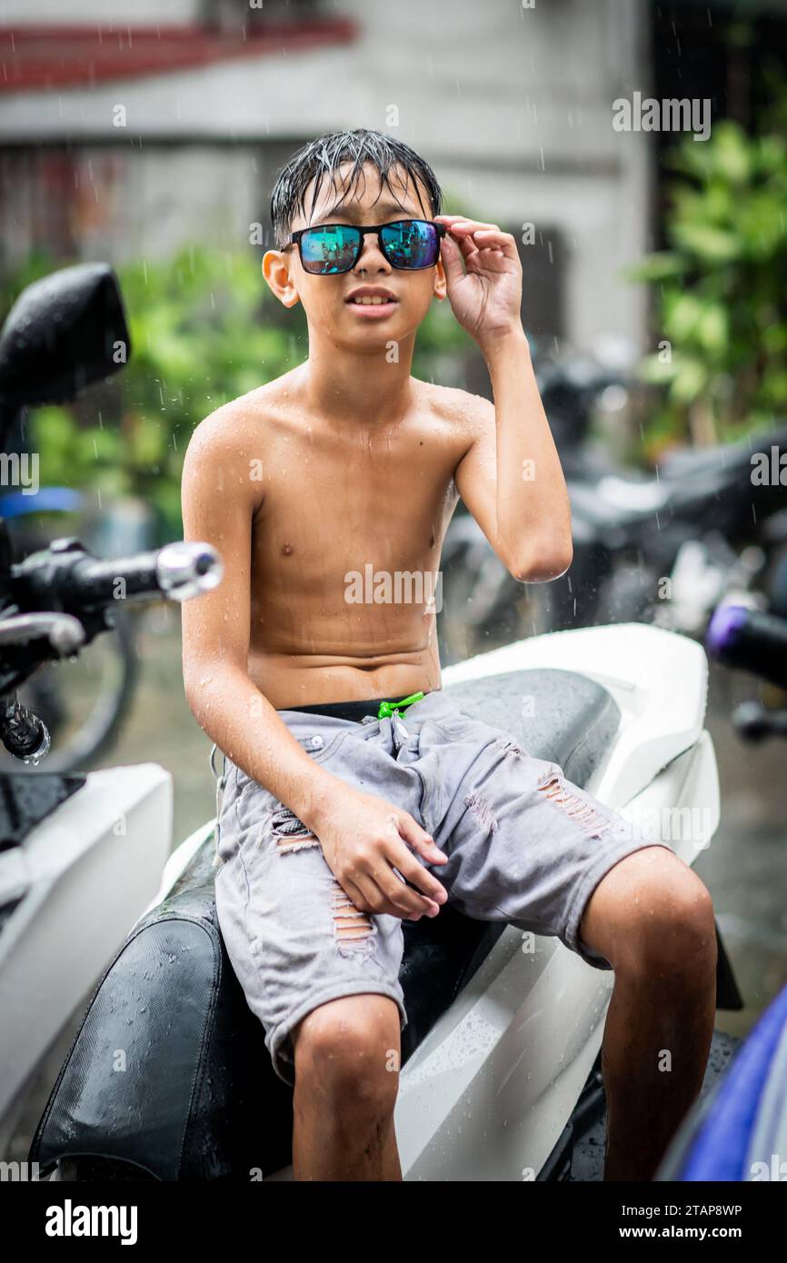 A cool little Filipino boy strikes a cool pose with his shades on in ...