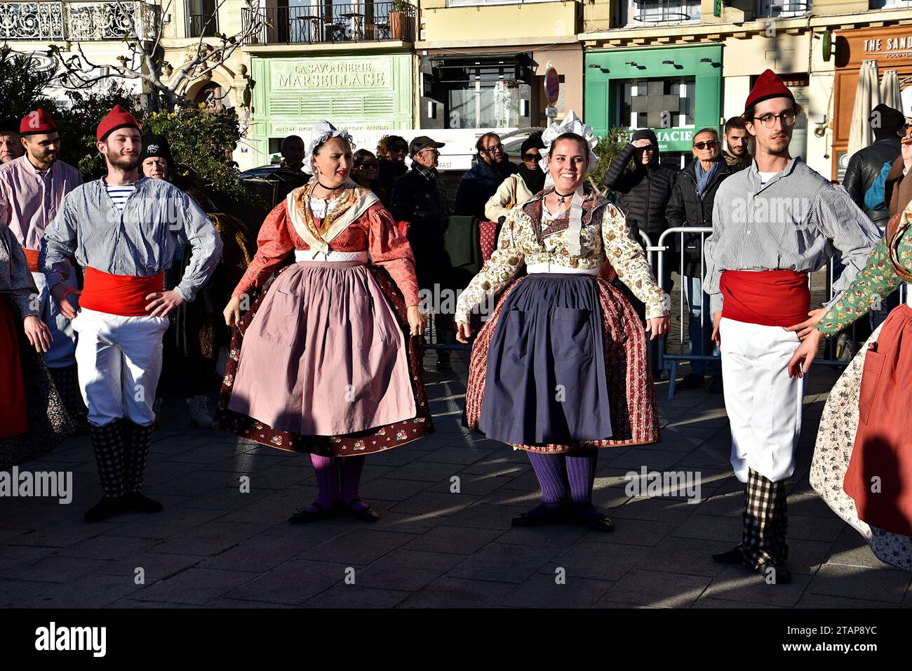 A group of folk dancers in traditional Provençal costumes are seen ...