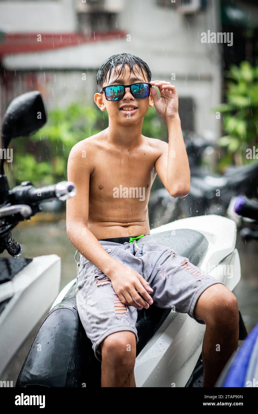 A cool little Filipino boy strikes a cool pose with his shades on in ...