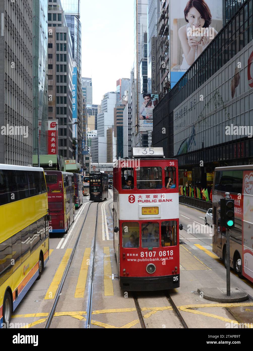 HONG KONG - JUNE 29, 2014: Double decker tram and buses on a street in ...