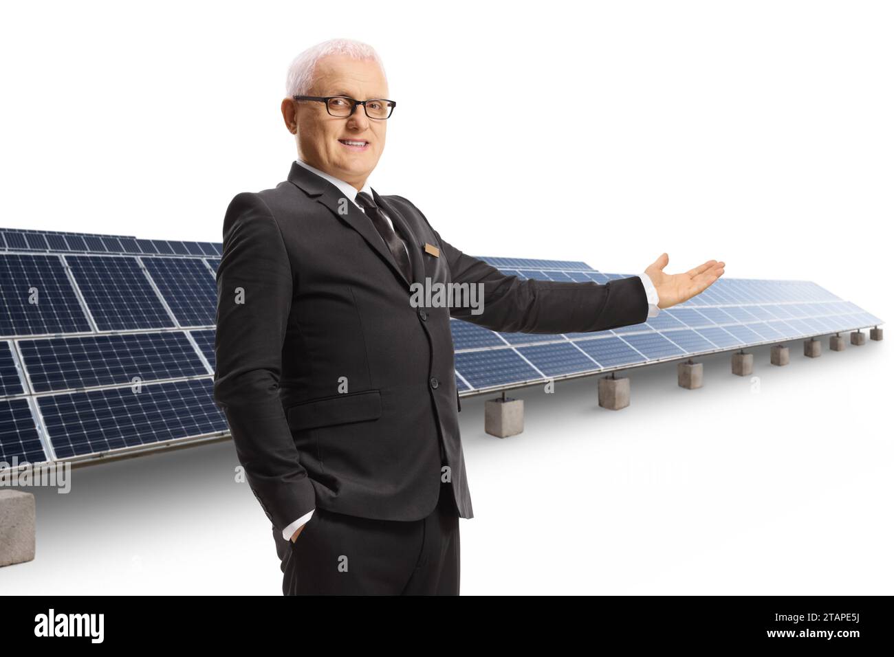 Mature man in a black suit presenting solar panels isolated on white ...