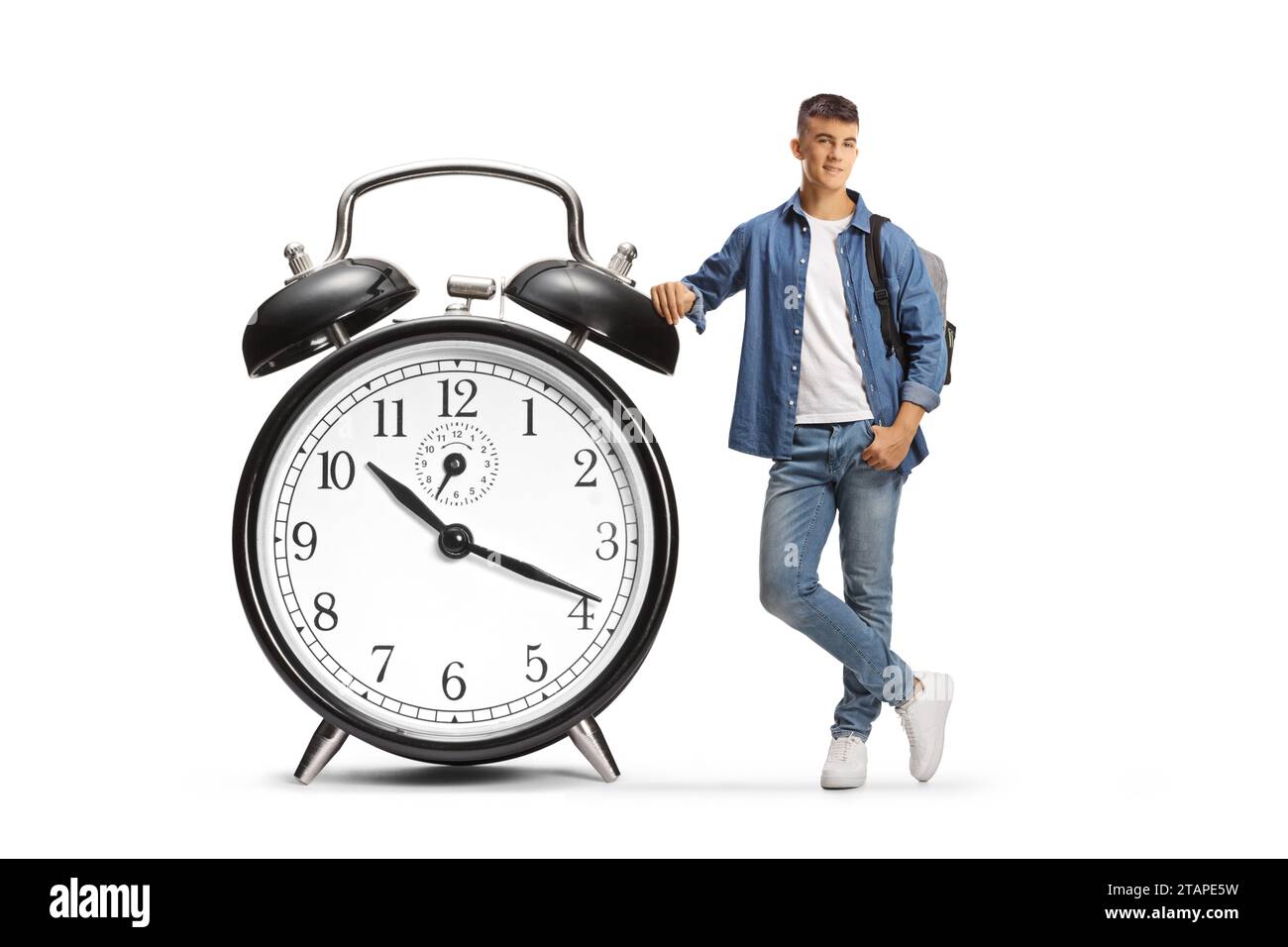 Student leaning on a big alarm clock isolated on white background Stock ...