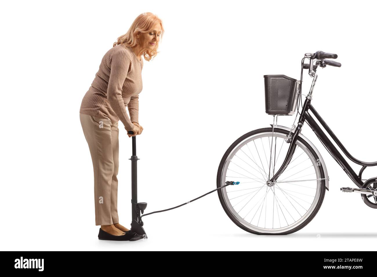 Woman using a manual pump for a flat bicycle tire isolated on white ...