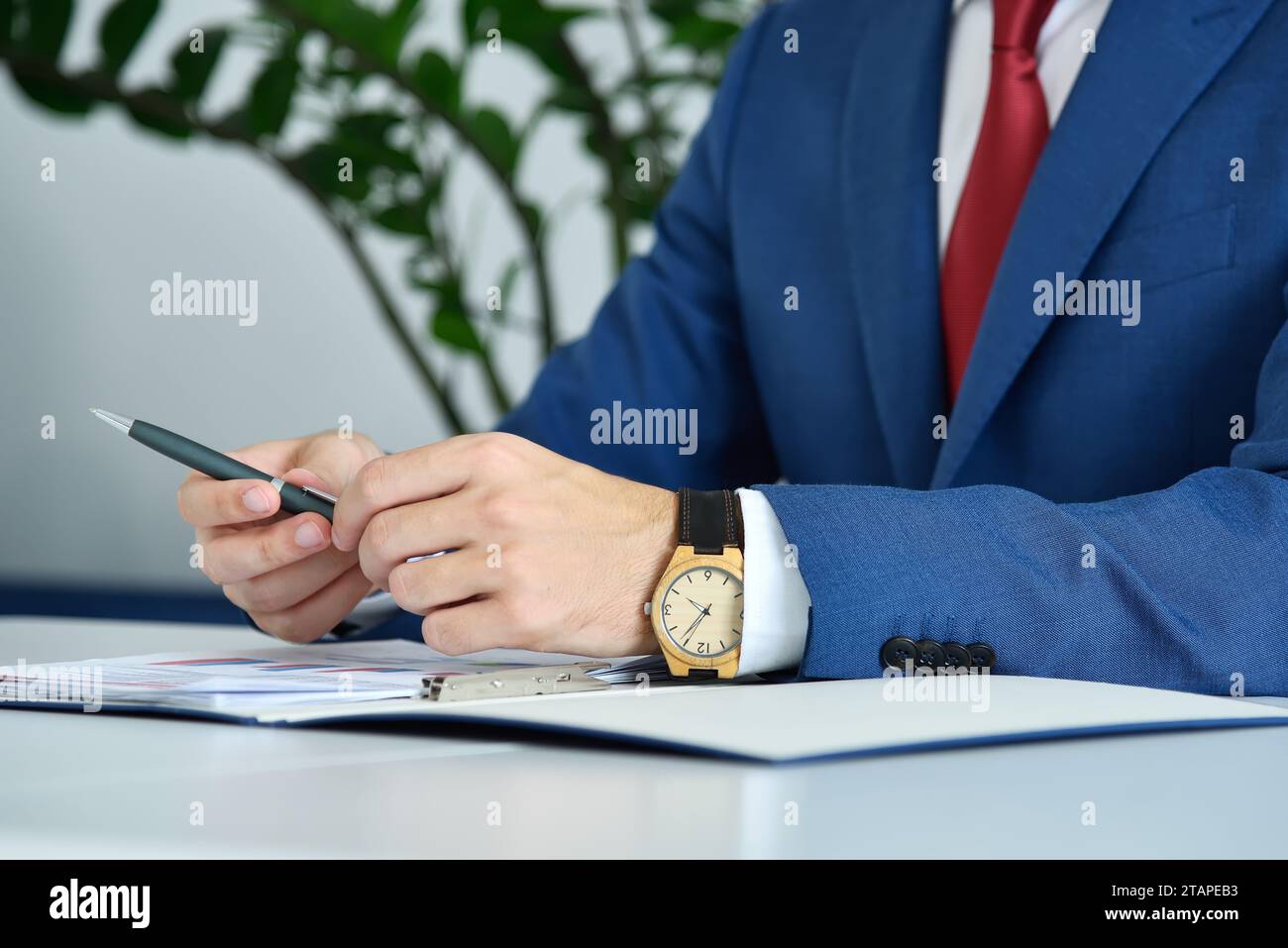 Trader man in suit sitting in office and analyzing report. Business and ...