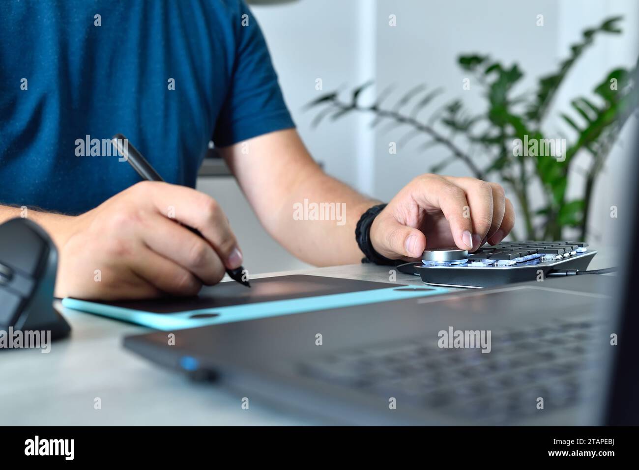 Designer drawing on graphic tablet and navigation control wheel ...