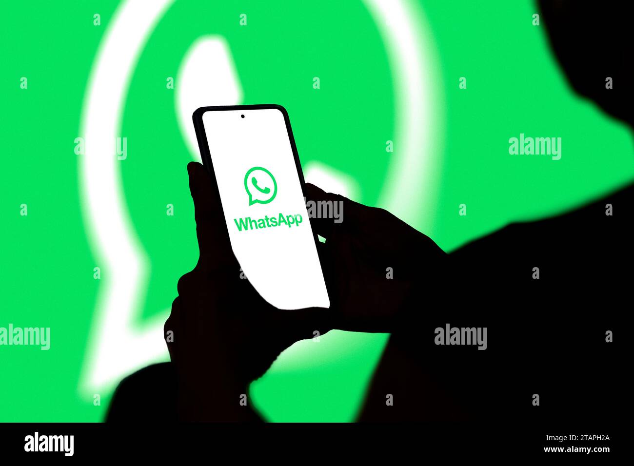 Whatsapp in mobile phone. Woman holding a smartphone in her hands with ...