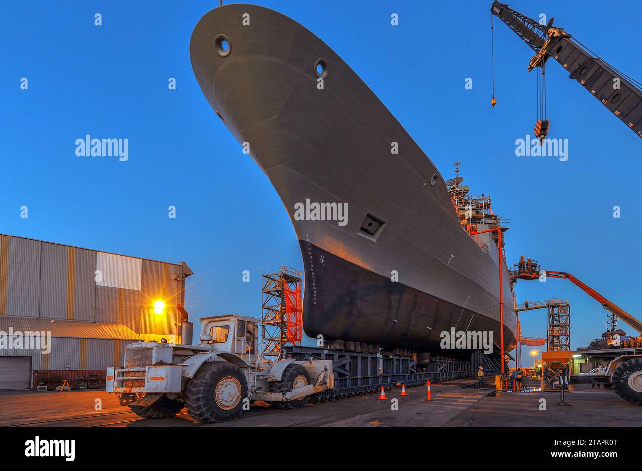 A bow view at dawn, of a Royal Australian Navy frigate on the hard ...
