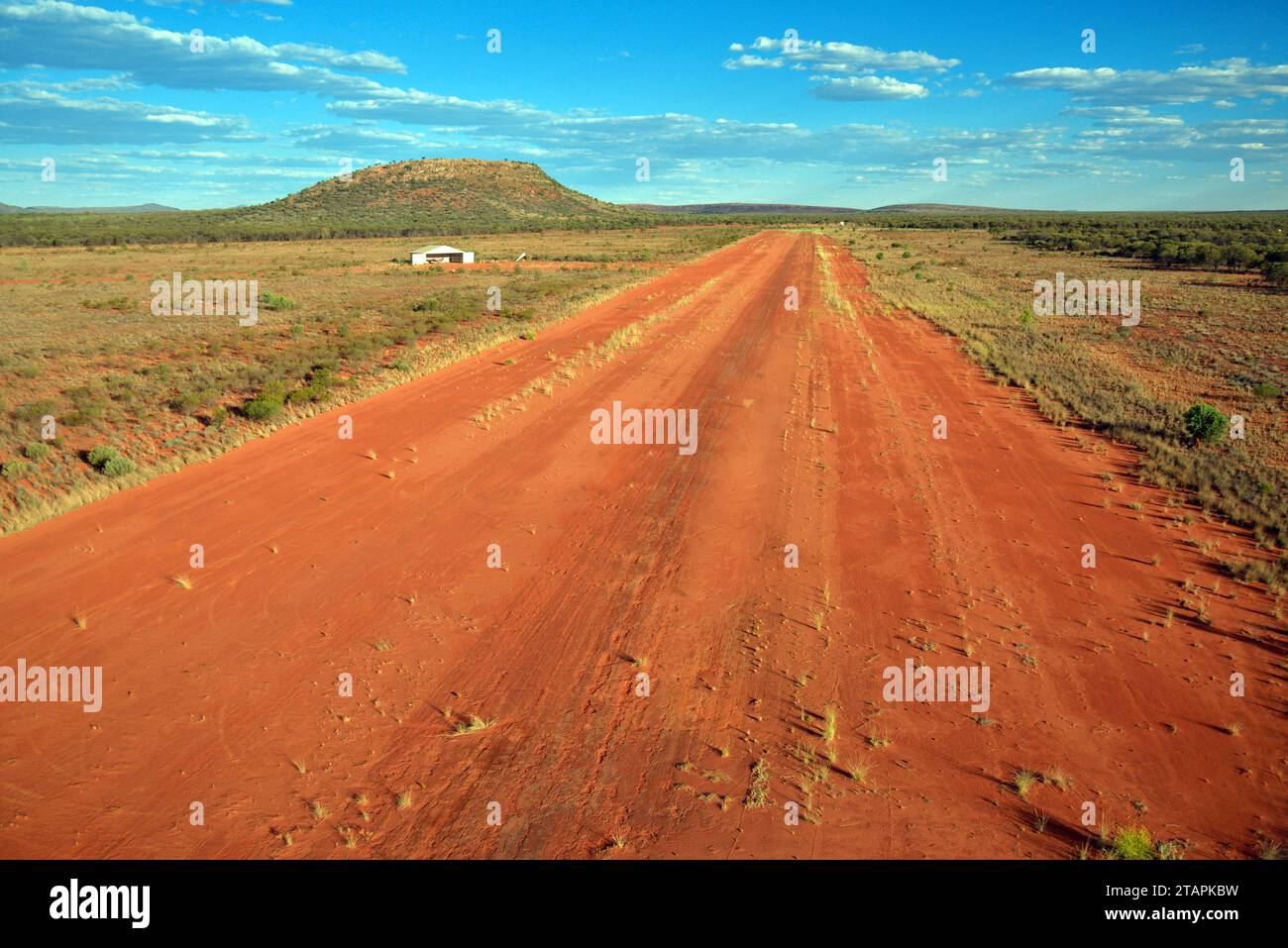 An aerial view of the approach to a red earth airstrip in the ...