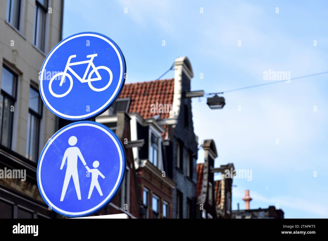 The street signs indicating bicycle and pedestrian pathways on a city ...