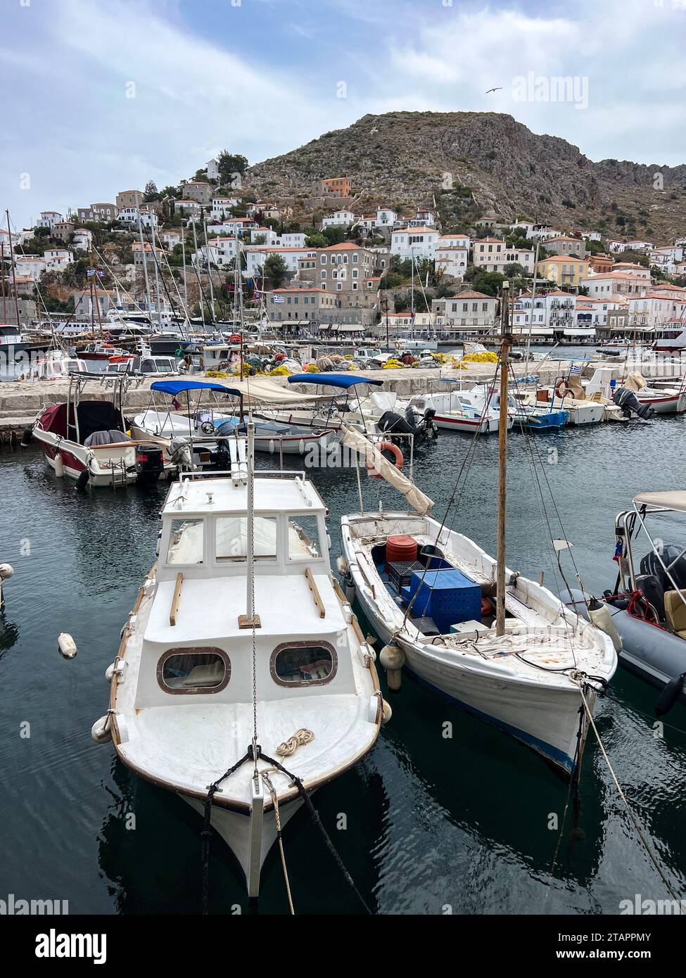 Waterfront villagescape with Boats moored in the harbour, Hydra Port ...