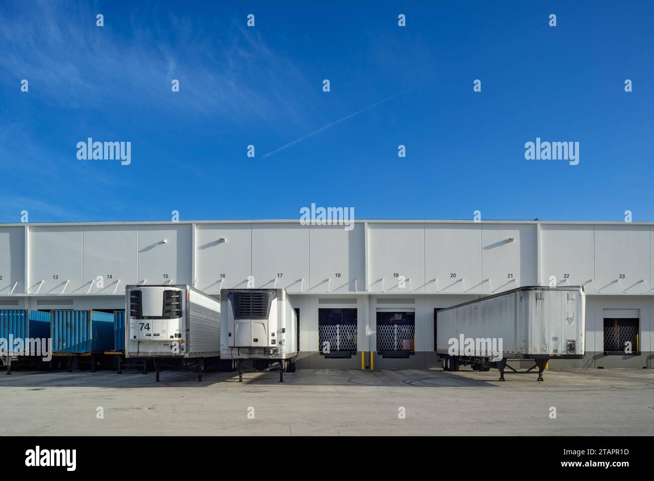 Trucks parked at warehouse loading dock area Stock Photo - Alamy
