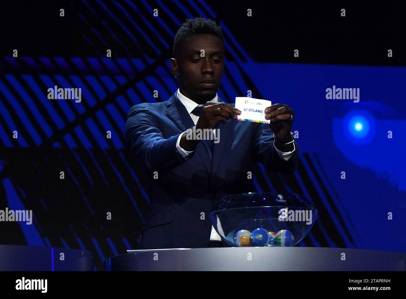 Former France player Blaise Matuidi pulls of the card of Scotland which ...