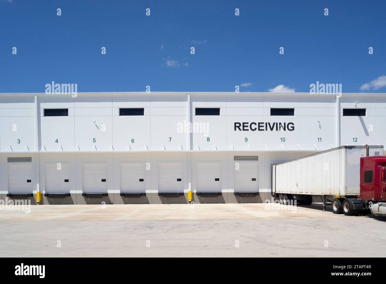 Trucks parked at warehouse loading dock area Stock Photo - Alamy