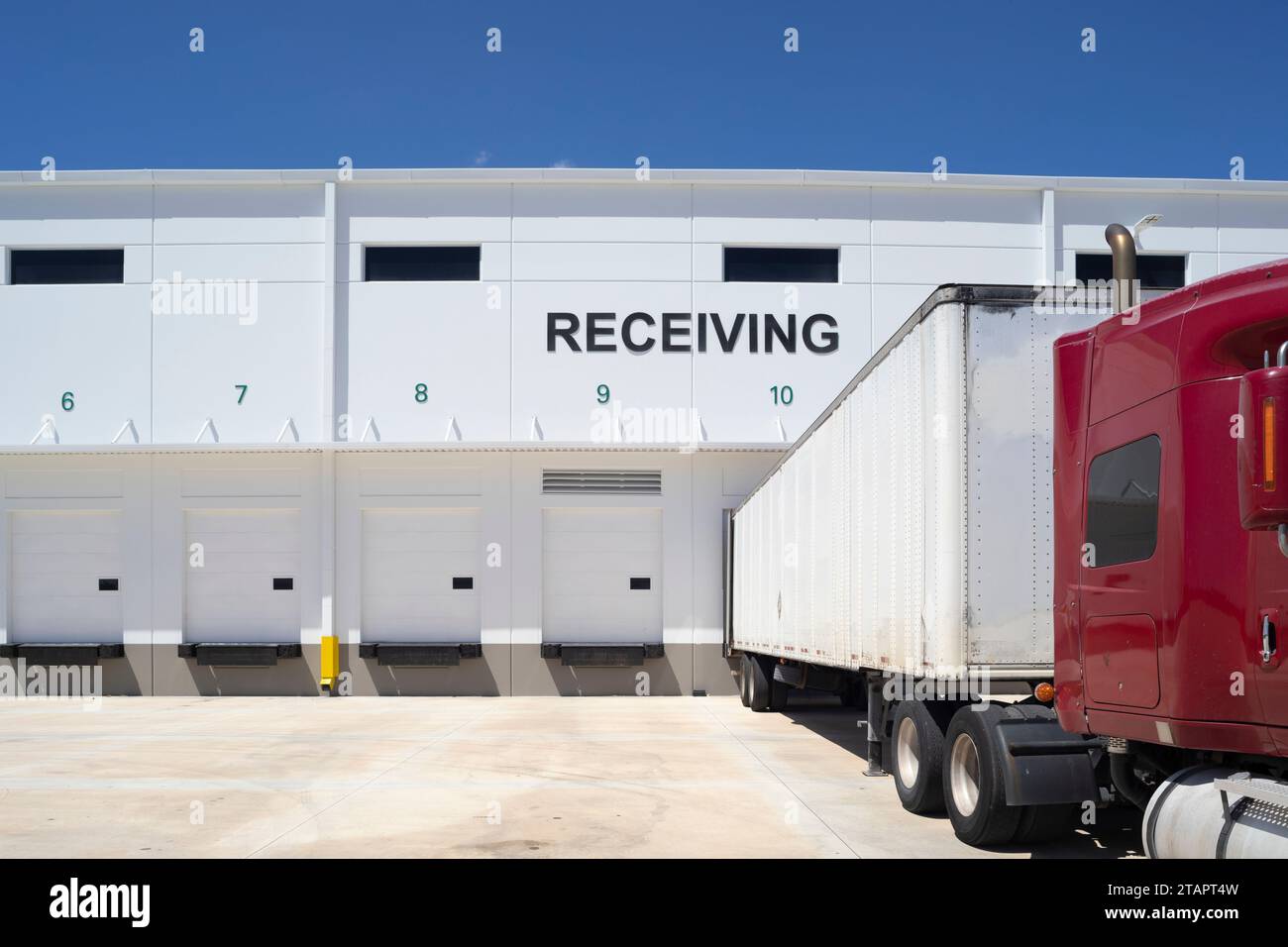 Trucks parked at warehouse loading dock area Stock Photo - Alamy