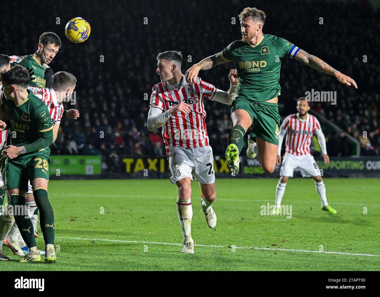 Dan Scarr #6 of Plymouth Argyle heads the ball but misses the target ...