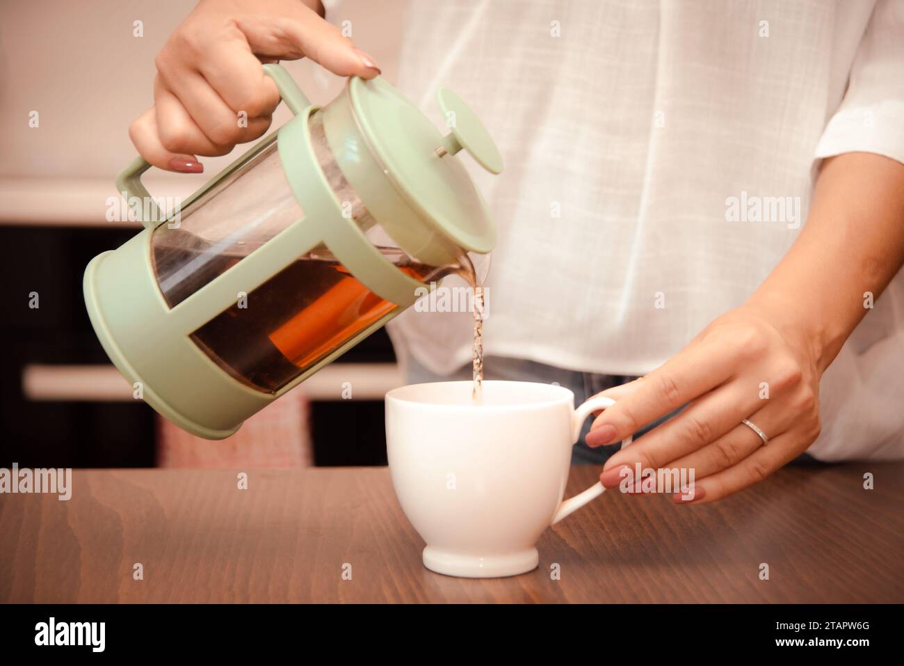 transparent teapot in woman hands. break for tea in work Stock Photo ...