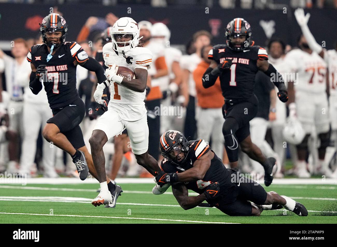 Texas wide receiver Xavier Worthy (1) is tackled after a long gain by ...