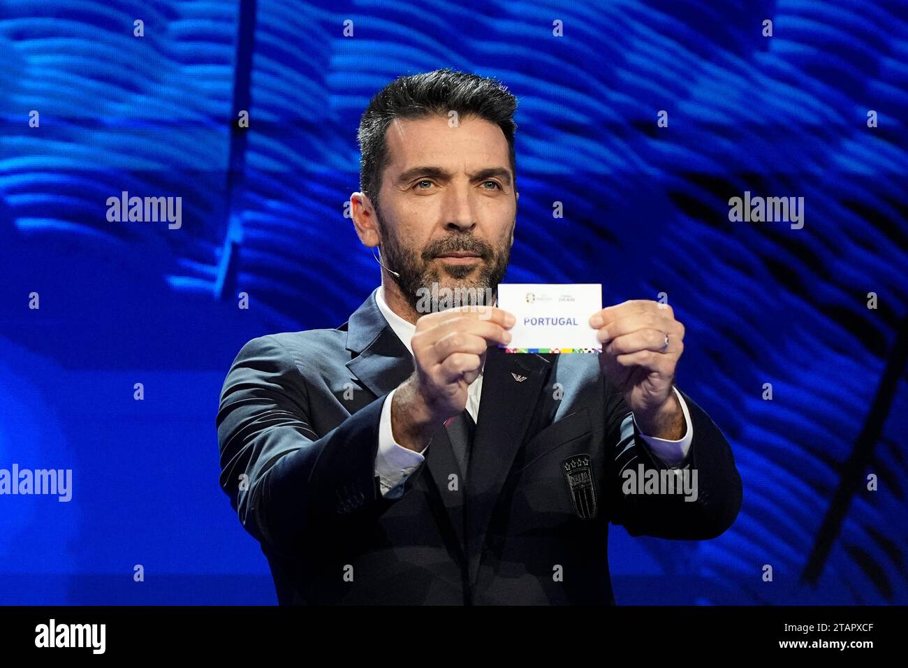 Former soccer player Gianluigi Buffon holds up the name Portugal during ...