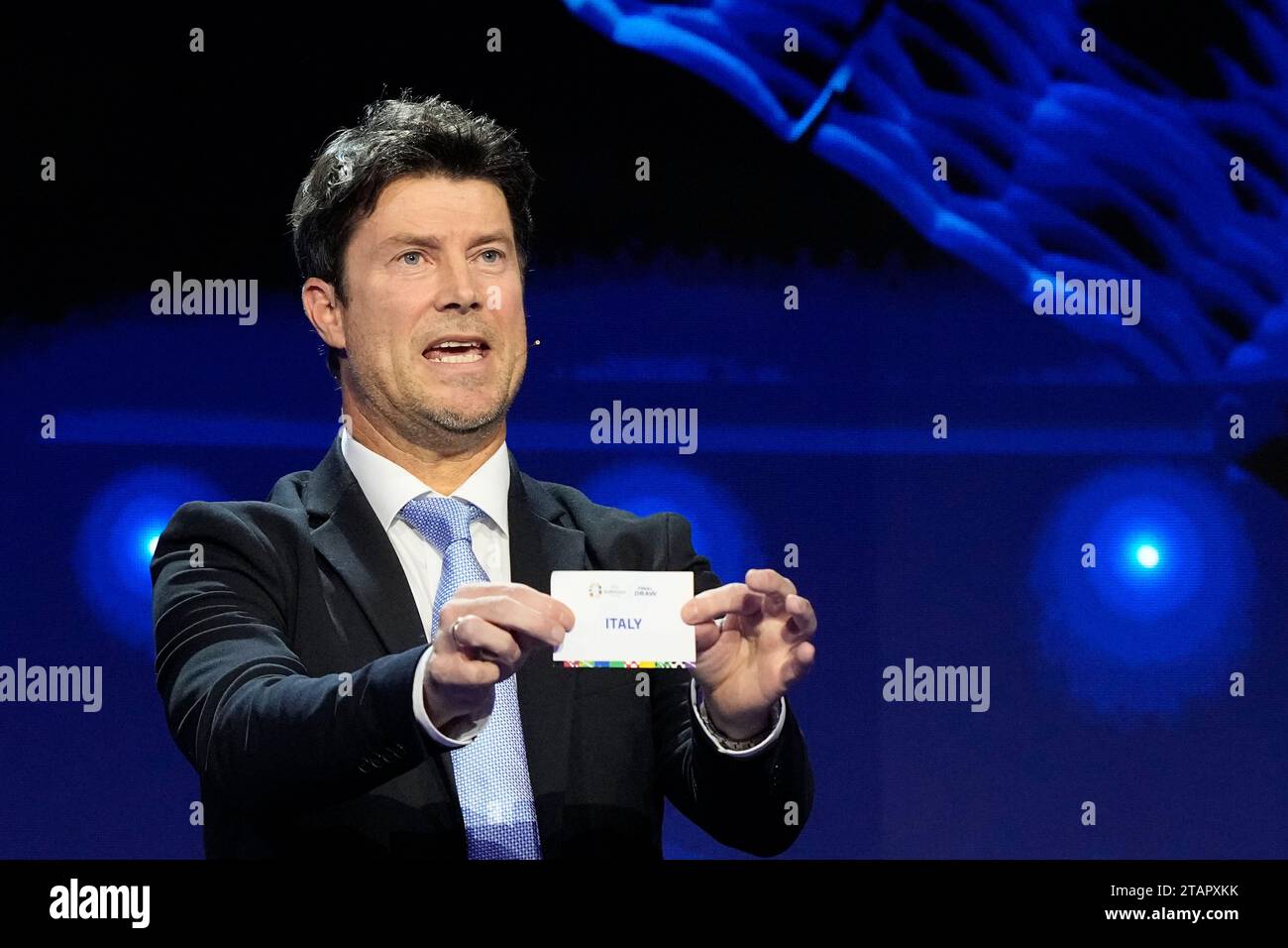 Former soccer player Brian Laudrup holds up the name Italy during the ...