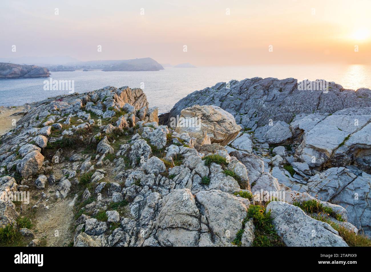 Sunset over the Santander Bay, coastal cliffs, the Cantabrian sea, and ...