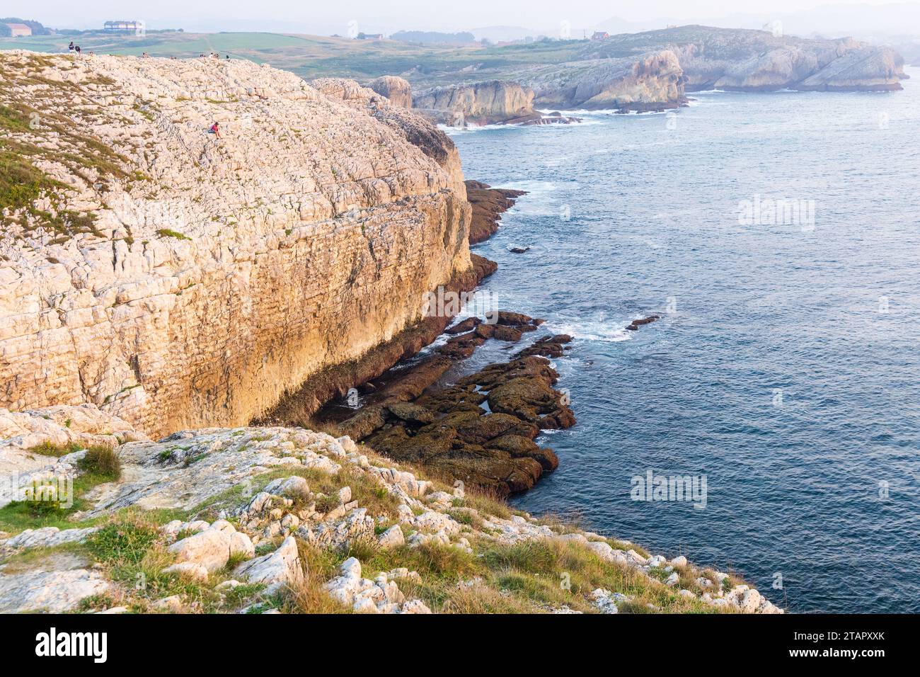 Coastal cliff, people gathering to watch the sunset, the Cantabrian sea ...