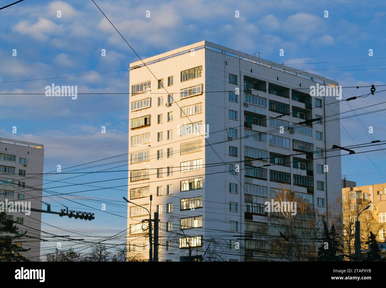 Close-up of a Soviet white high-rise building illuminated by the ...