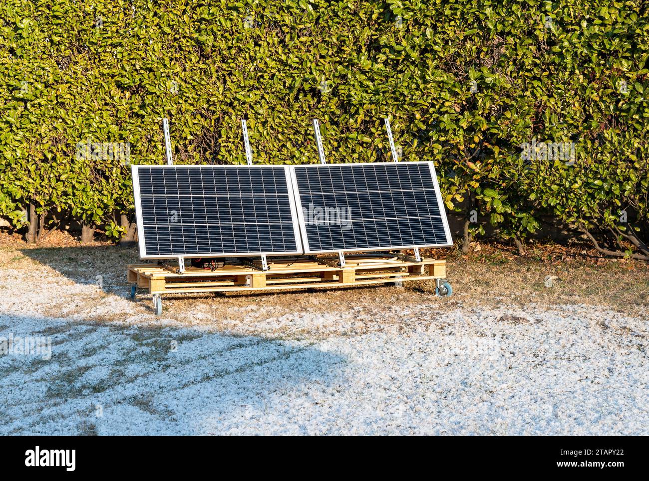 Photovoltaic panels on the wooden pallet in the home garden at winter ...