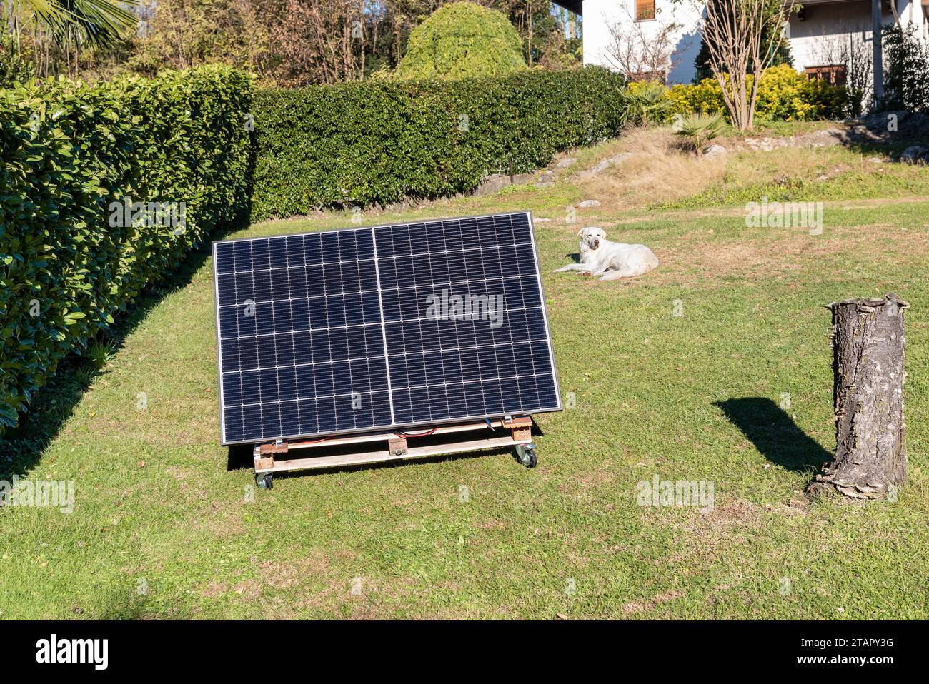 Photovoltaic panels on the wooden pallet in the home garden. Green ...