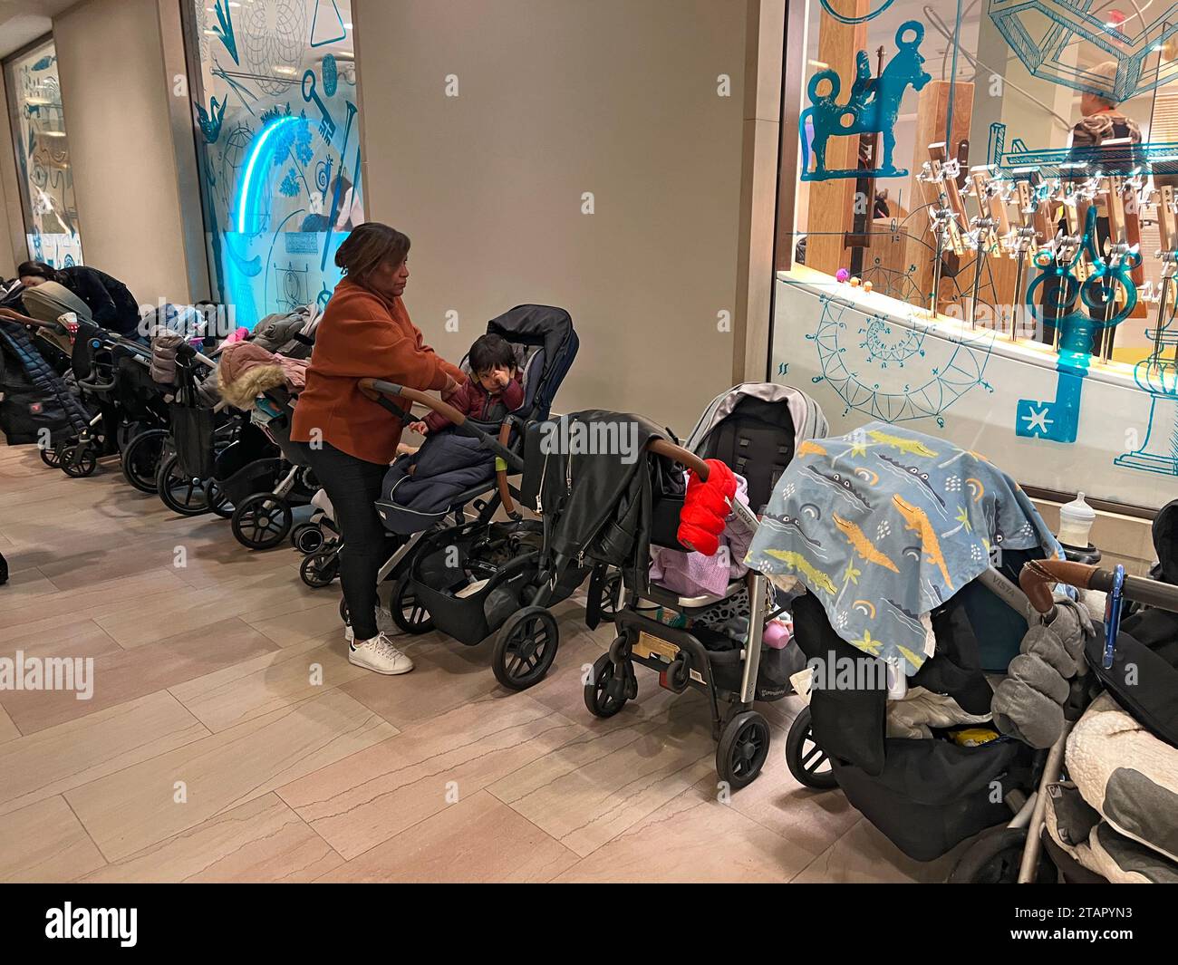 Nanny with a child amidst a line of child strollers at the Metropolitan ...