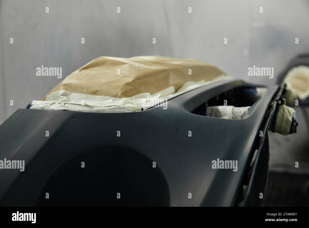 The photograph captures the scene of an automotive workshop, showcasing ...