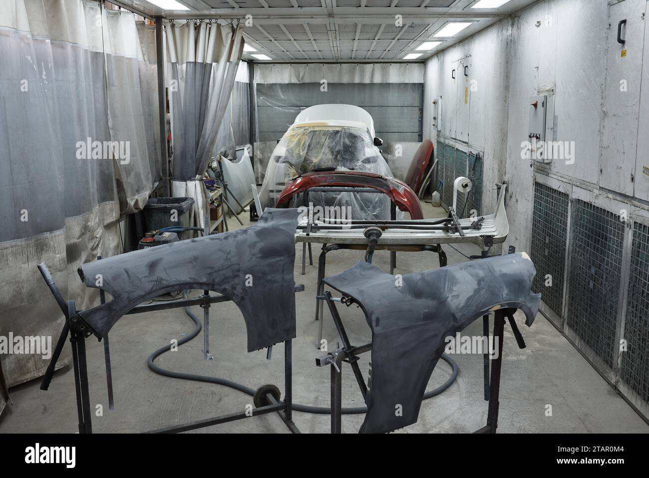 The photograph captures the scene of an automotive workshop, showcasing ...